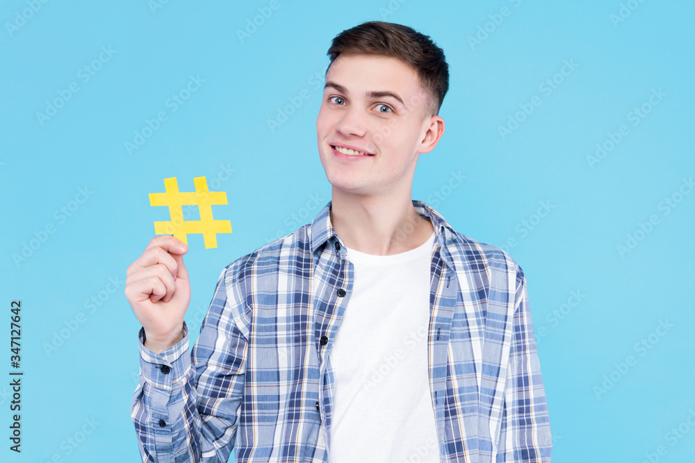 Young man user of social media in white t-shirt, checkered shirt is ...