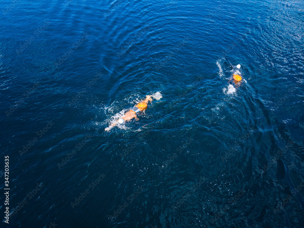 Arctic people swim ice hole in cold water, athletes in wetsuits with ...
