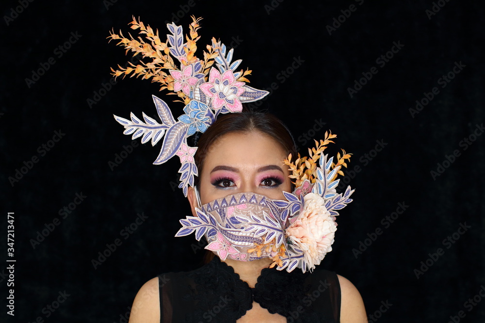 Beautiful Chinese female close up wearing flower art arrangement mask ...