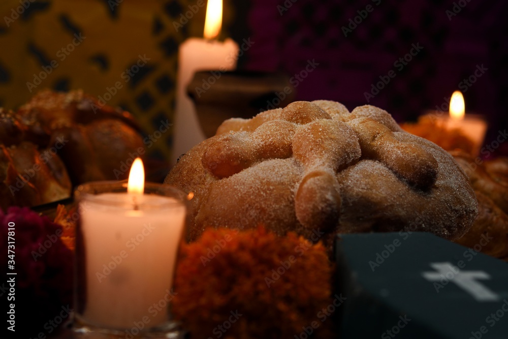 Sugar-coated dead bread, around it marigold flowers, lighted candles ...