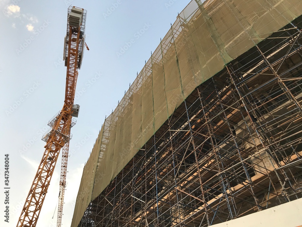 Project Site Construction under progress using tower crane and ...