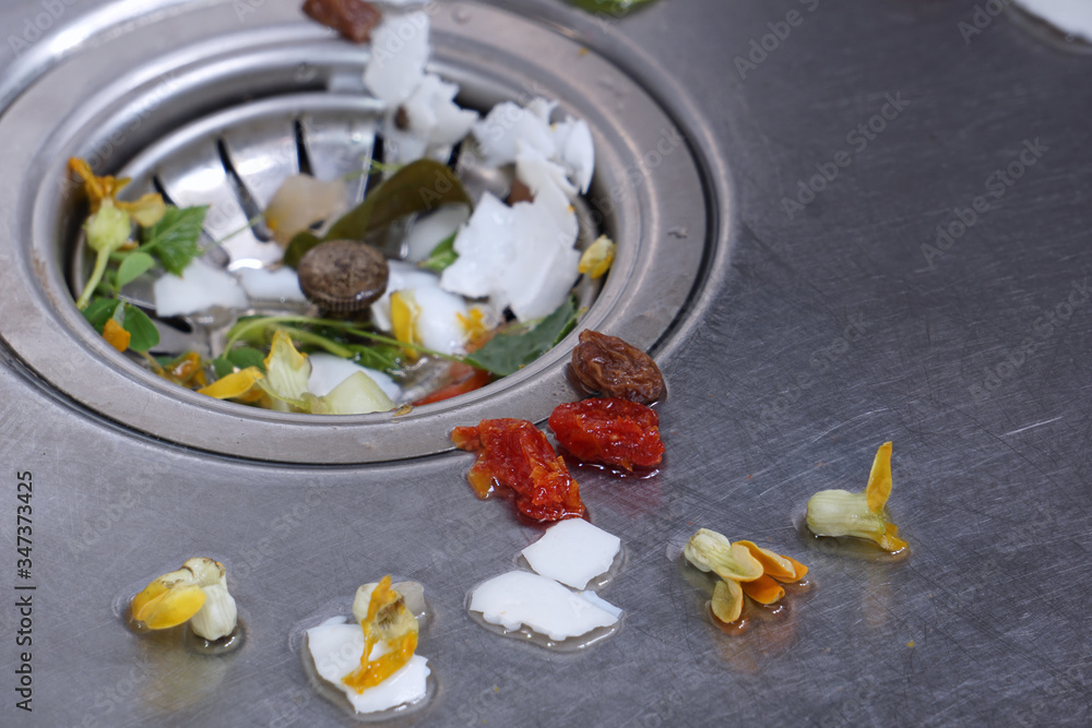 Food waste from the washing up in the sink and trash traps grid of ...
