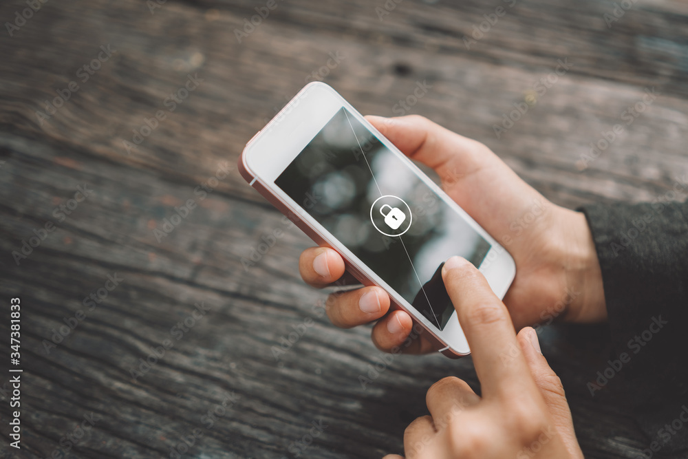 Woman hand using smart phone with lock icon graphic at coffee shop ...