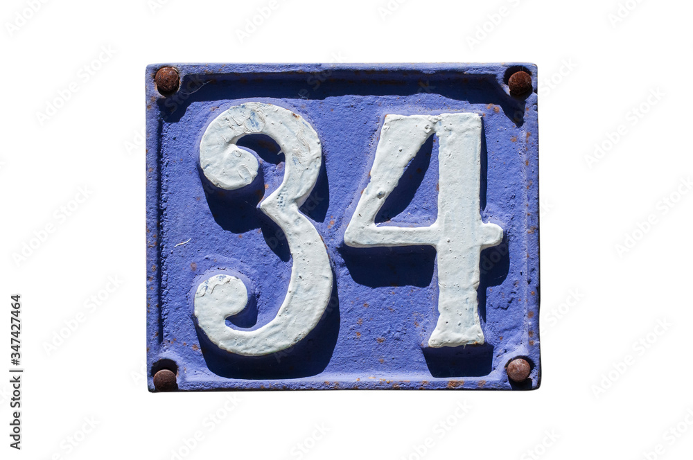 Old retro weathered cast iron plate with number 34 closeup isolated on ...