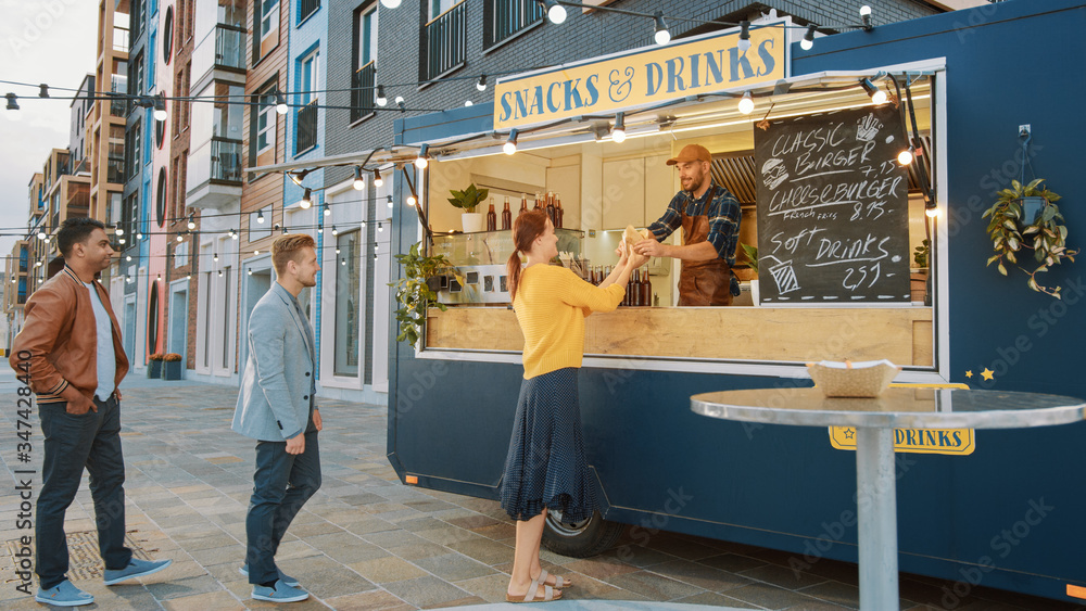 Food Truck Employee Hands Out a Freshly Made Gourmet Burgers to a Happy ...