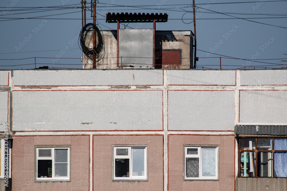 Part of an old multi-storey panel house. The Windows of the apartments ...