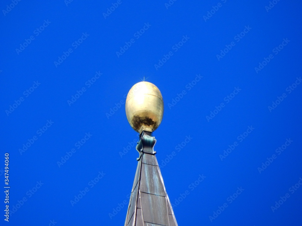 Golden sphere as lightning arrester with blue sky background and copy ...