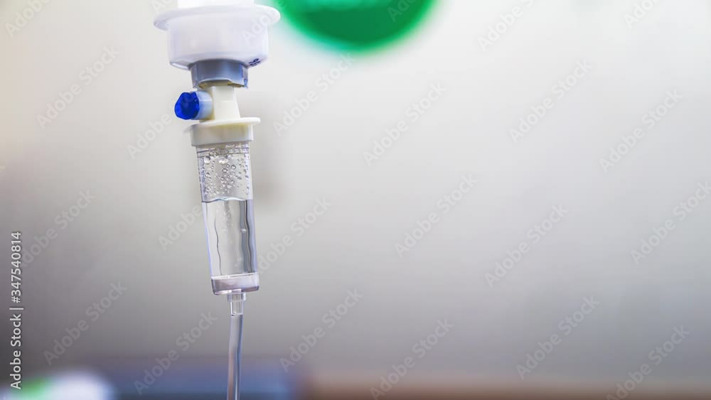 Cinemagraph of a fluid intravenous saline drip in a hospital room ...