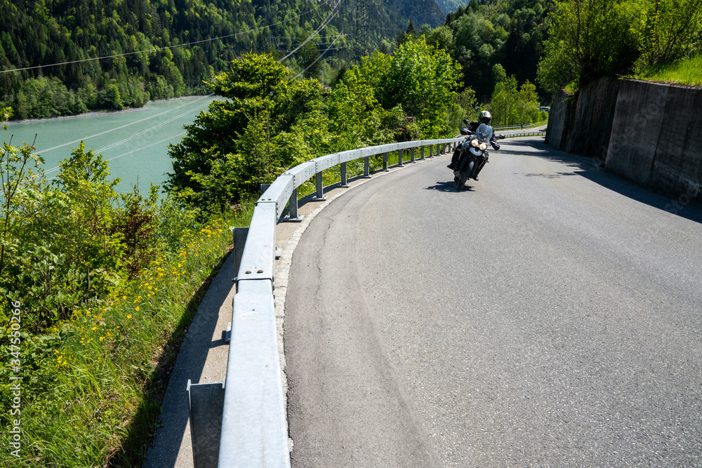 motorcycle rider enjoys a ride on the curving mountain roads in the ...