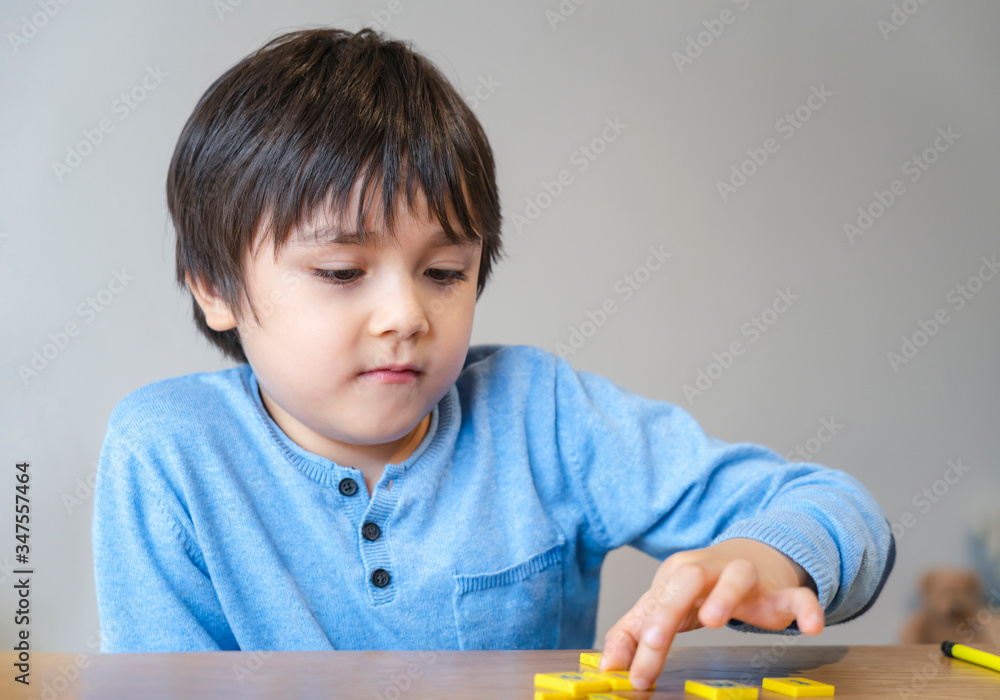 Preschool kid playing English words game,Child boy concentrated with ...