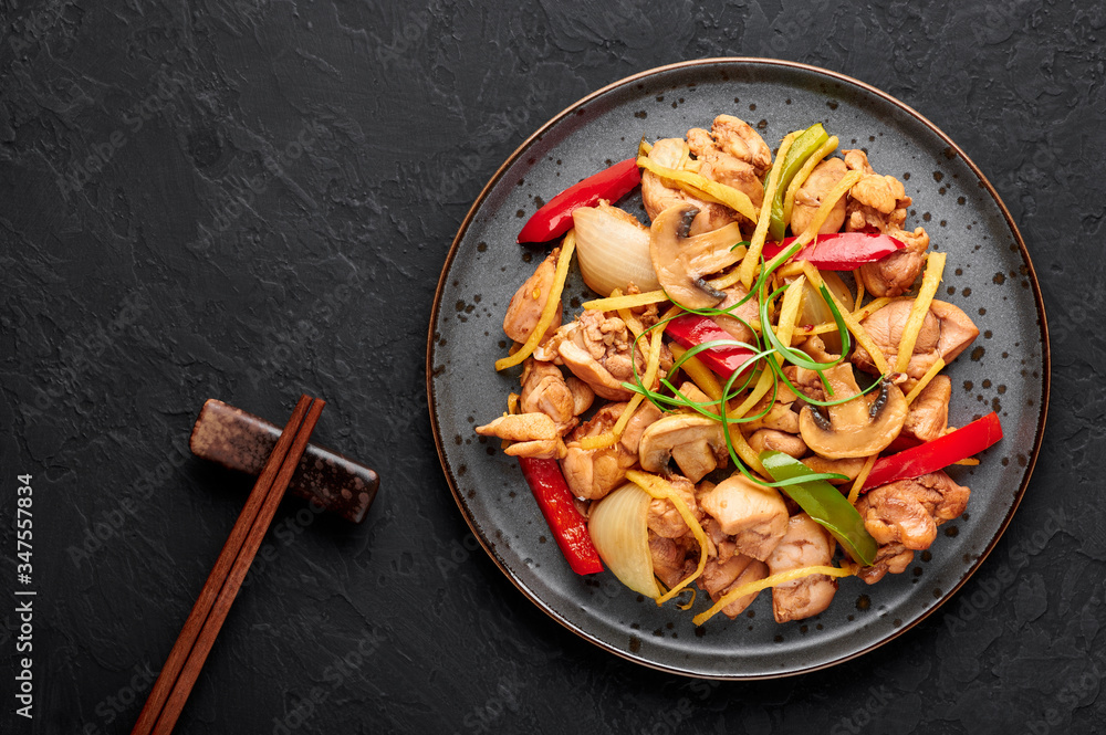 Thai Ginger Chicken or Gai Pad King in dark plate at black slate ...