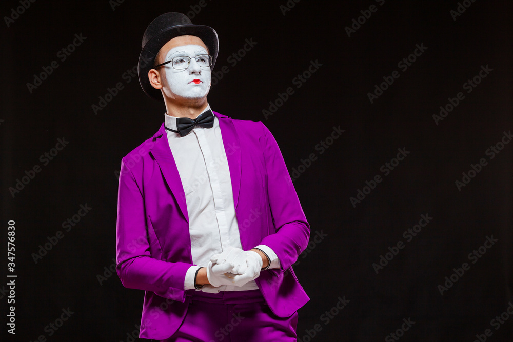 Portrait of male mime artist, isolated on black background. Young man ...
