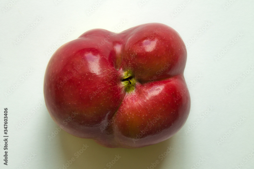 Curves of ripe red Apple close-up isolated. Trend-ugli fruit Stock ...
