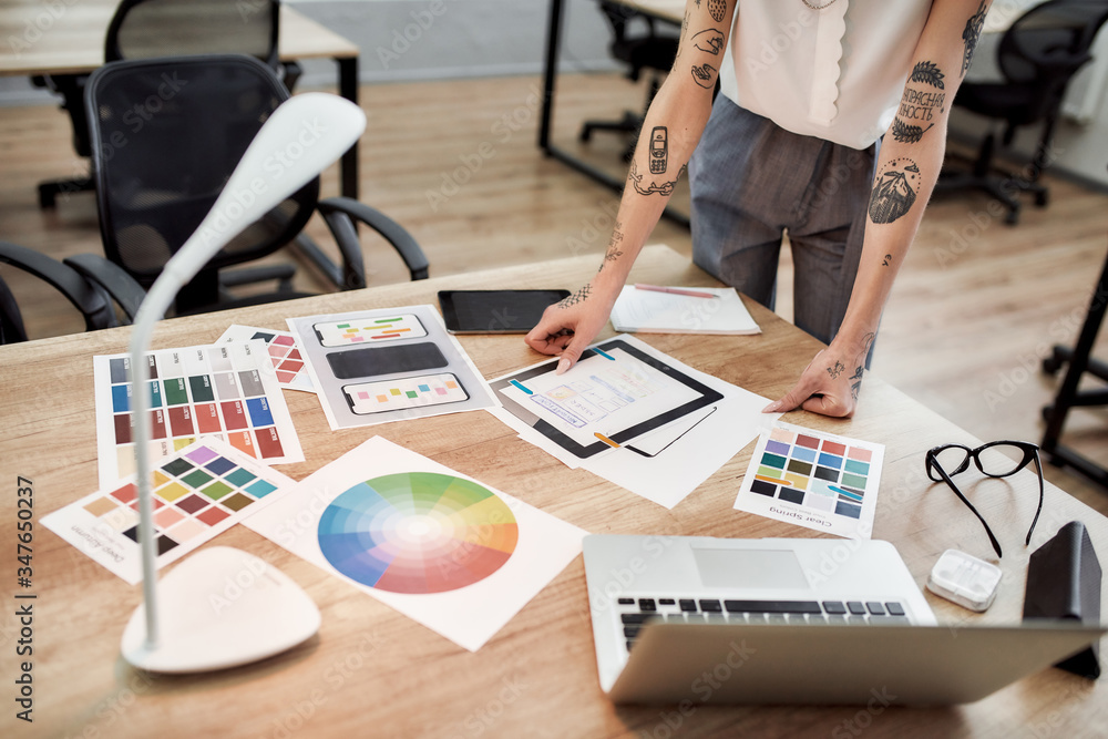 Graphic designer at work. Cropped view of tattooed female designer ...