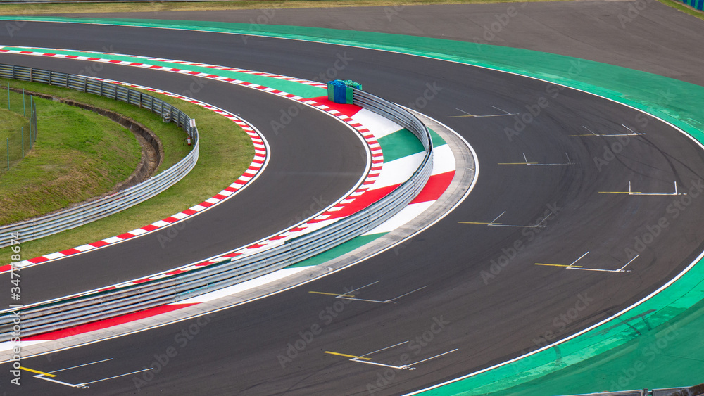 Motor racing circuit Red and White Kerb. A race track bend with grid ...