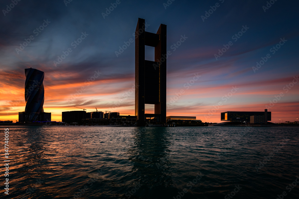 Silhouette high rise buildings from Bahrain Bay after sunset, Manama ...
