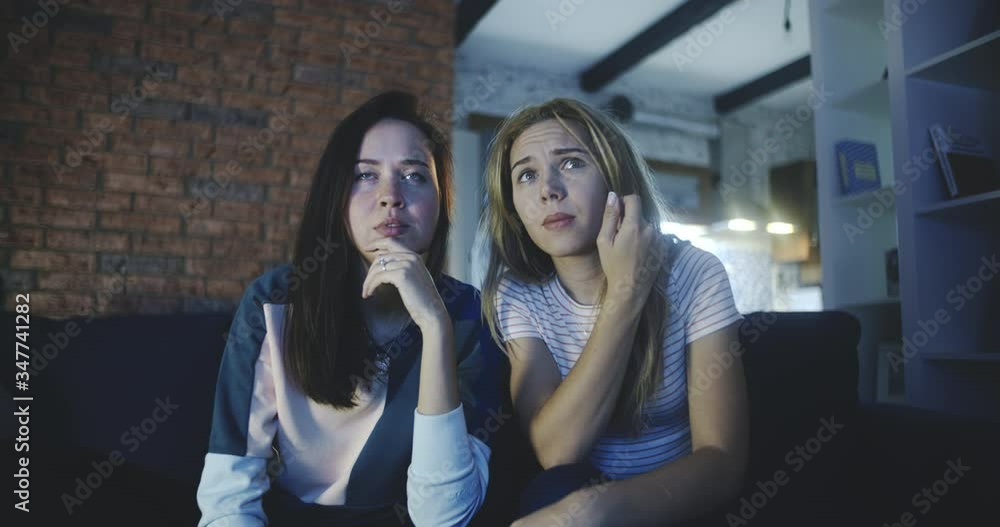 Two girls watching thriller movie at home. Teenage, friendship ...