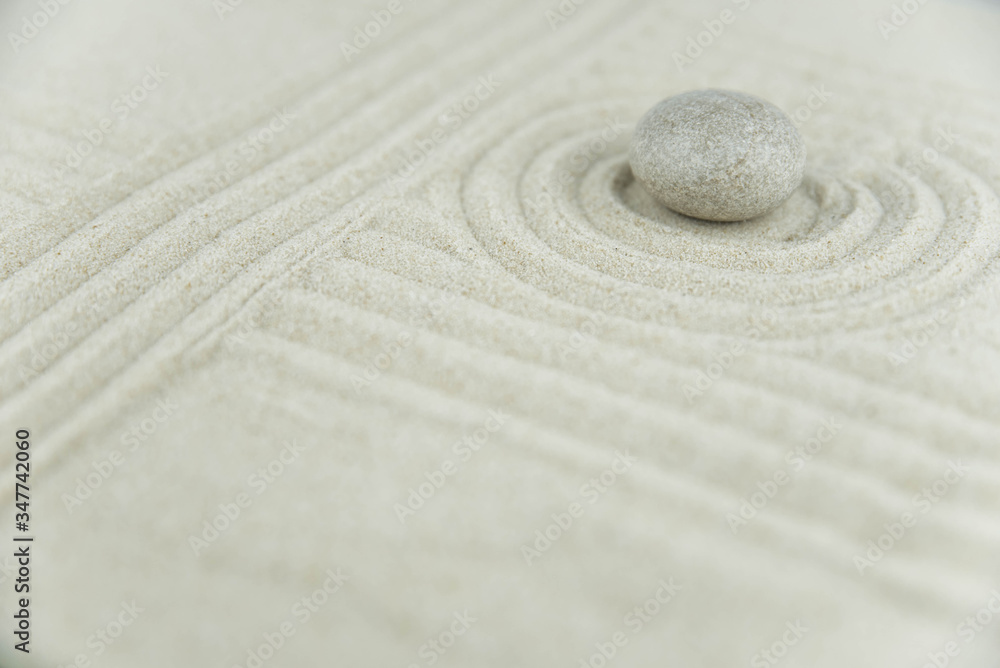 Zen garden. Pyramids of white and gray zen stones on the white sand ...