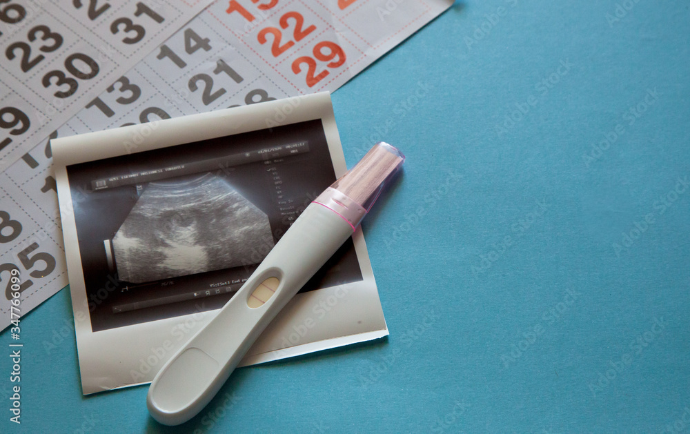 Ultrasound scan of an unborn baby of fifth week with a pregnancy test ...