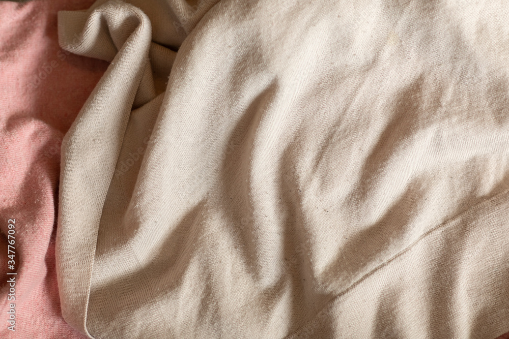 Old clothes in washed out pink colors laying on a pile. Worn pieces ...