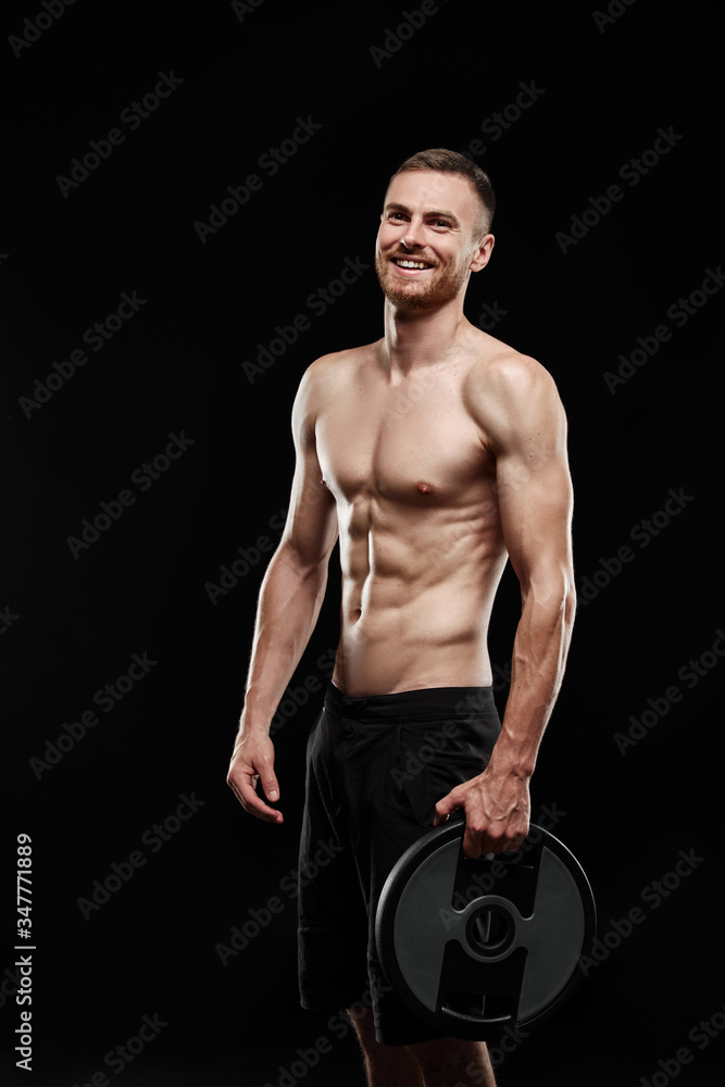 Strong athletic smiling man - athlete fitness model showing his perfect ...