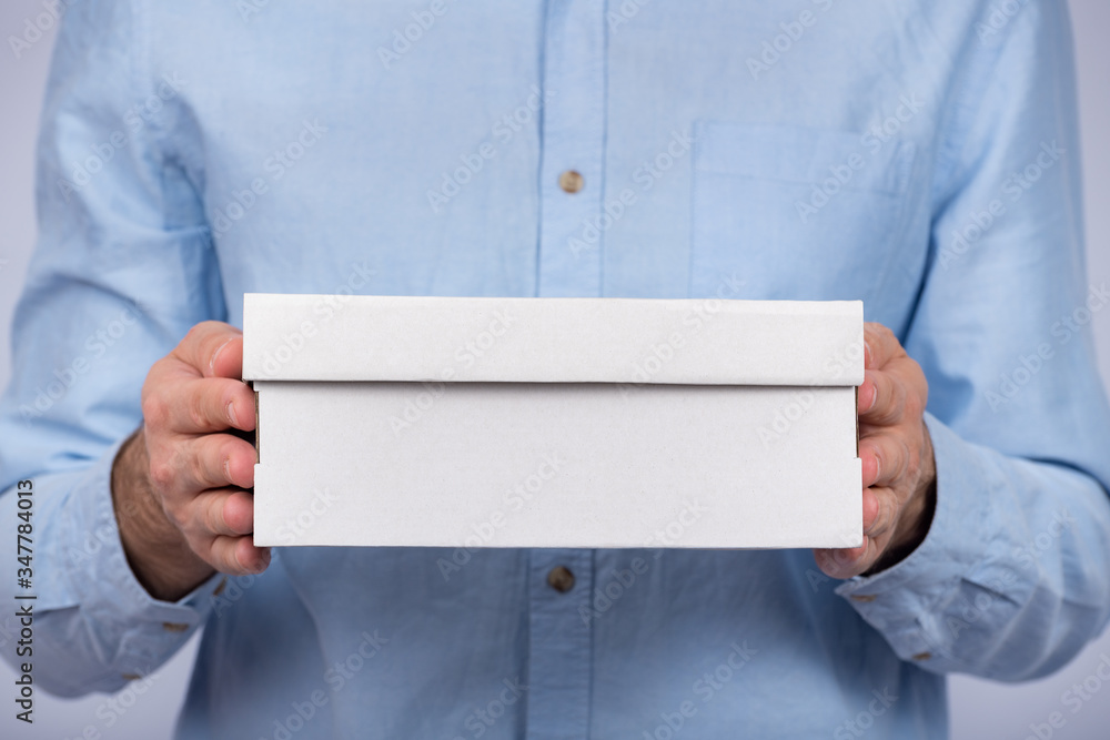 Male hands holding a cardboard box. Close up. Front view. Express ...