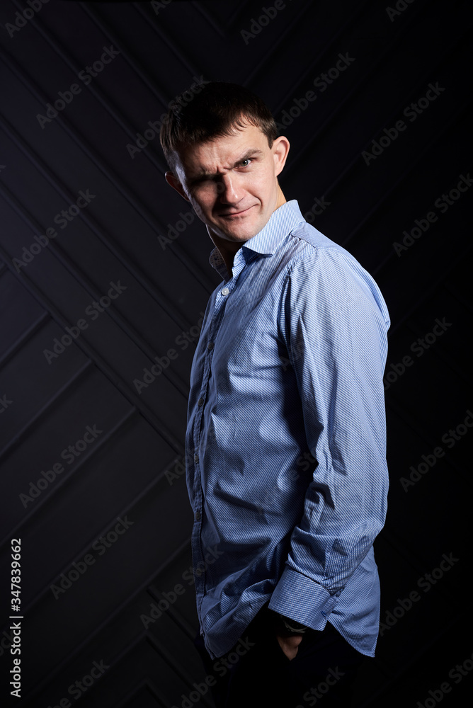 Young brunette man, wearing light blue shirt, posing for picture in ...