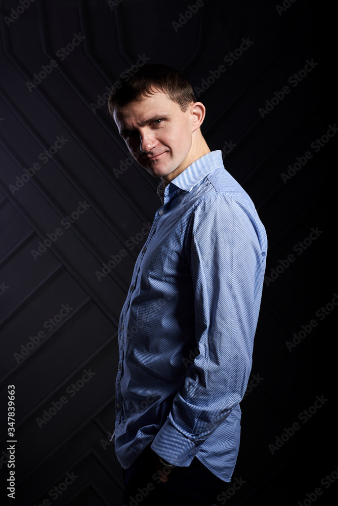Young brunette man, wearing light blue shirt, posing for picture in ...