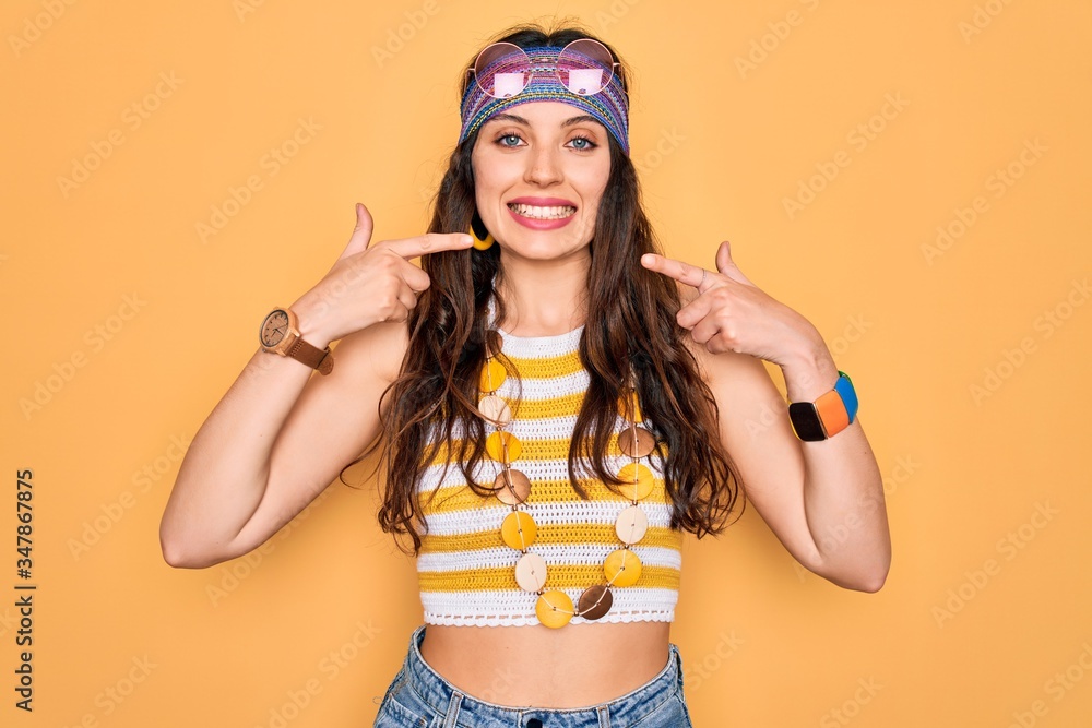 Young beautiful hippie woman with blue eyes wearing accesories and ...