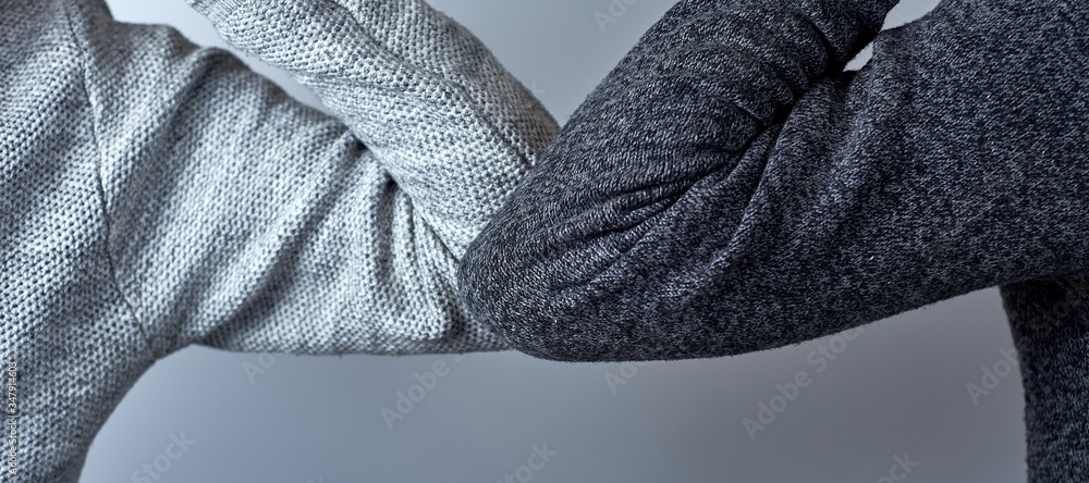 Elbow bump. New greeting to avoid the spread of coronavirus. Instead of ...