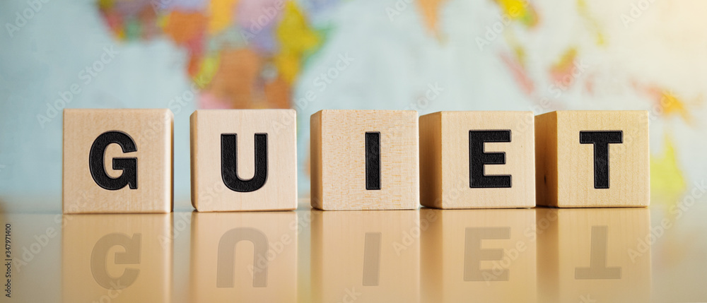 The word guiet symbol written on wooden cubes isolated on a political ...