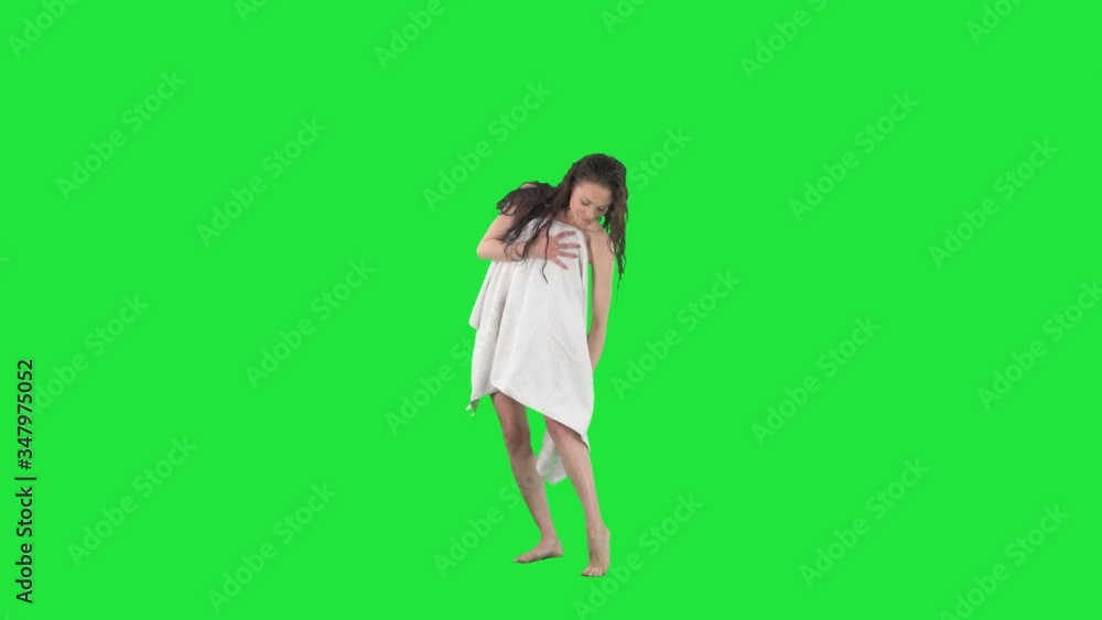 Young wet woman drying of and wiping body with white cotton towel slow ...