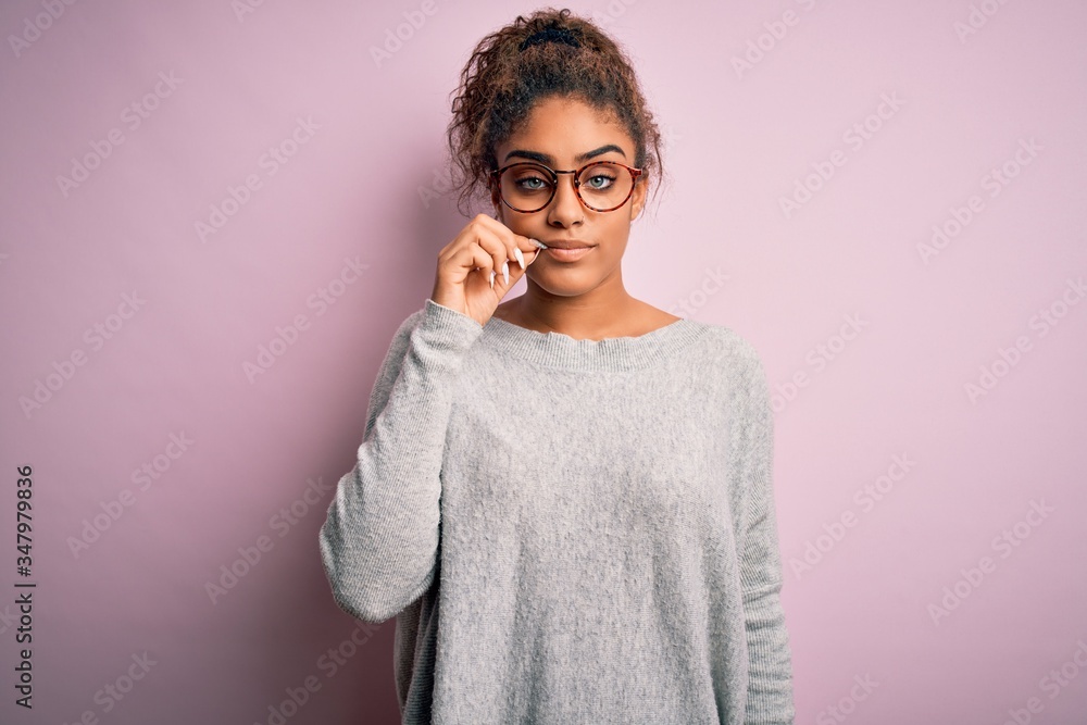 Young beautiful african american girl wearing sweater and glasses over ...