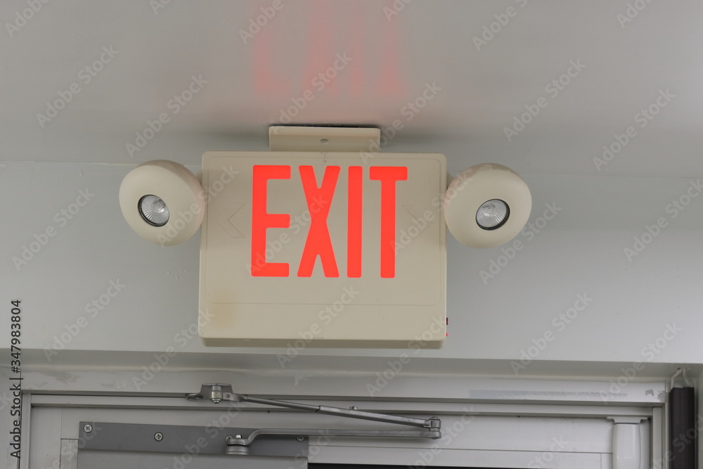 Illuminated exit sign above exterior door mounted on ceiling Stock ...