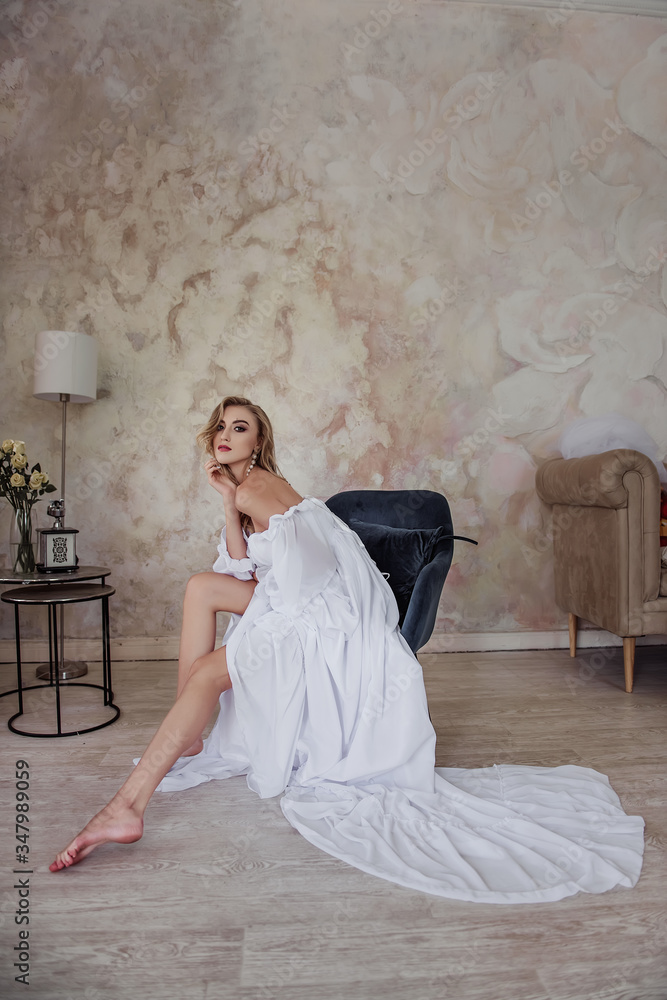 A beautiful girl with big, expressive eyes, long legs and blond hair in ...