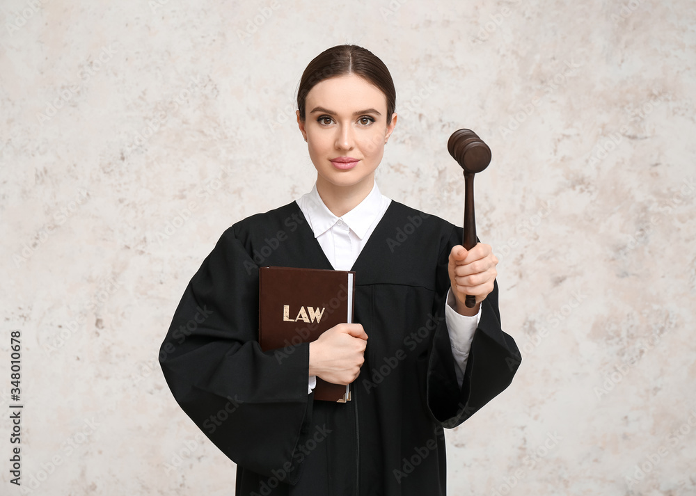 Female judge with book on light background Stock Photo | Adobe Stock