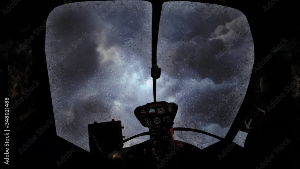 Plane cockpit flying through a turbulent thunderstorm. 4K shot of a ...