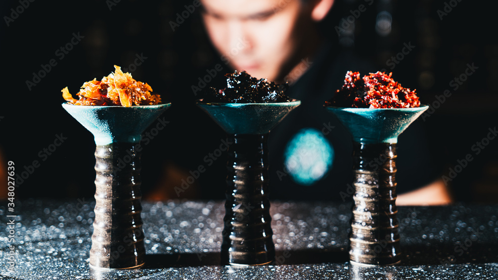 Side view of three different types of shisha tobacco in bowls Stock ...