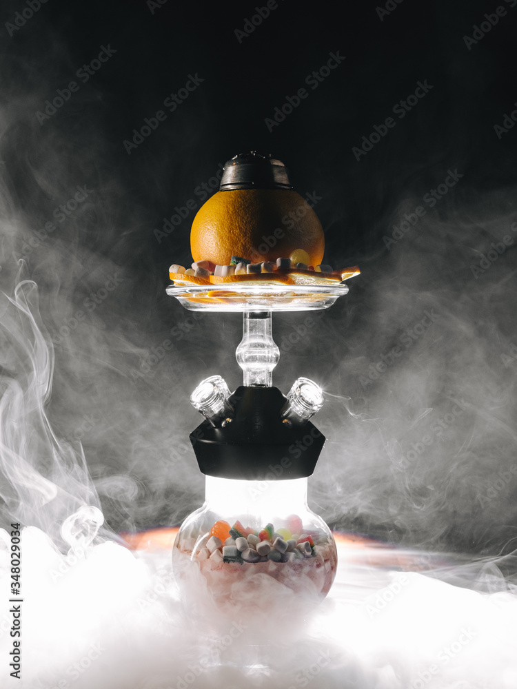 Sweet kalian with orange, candies and fluffy marshmallow on dark ...