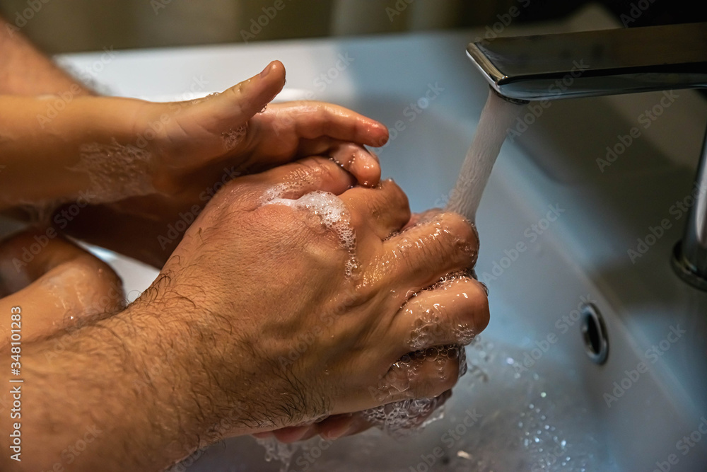 washing hands with soap. Washing a child’s hands with soap and water to ...