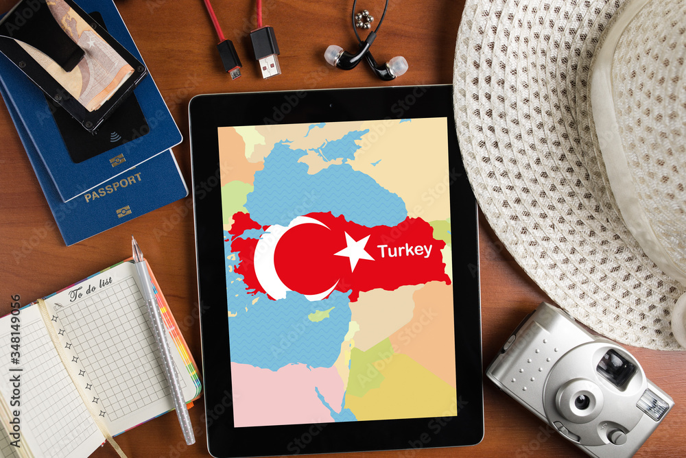 overhead view of traveler's accessories and map of Turkey on tablet ...