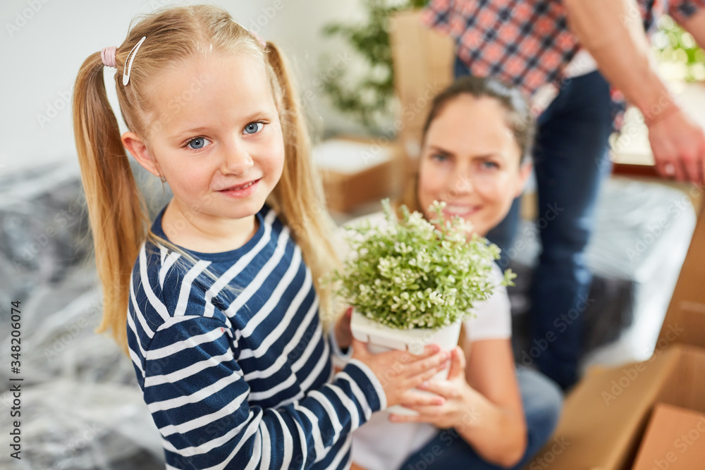 Girl helps to carry plants Stock Photo | Adobe Stock