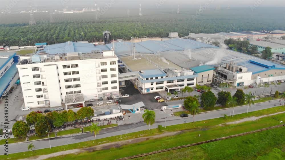 Full View Of Factory With Smokes and Vehicle Passing Through On ...