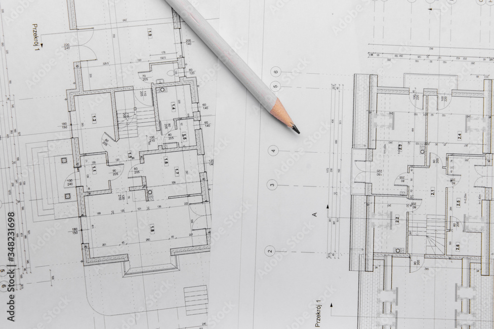 Architect rolls and architectural plan, technical project drawing ...