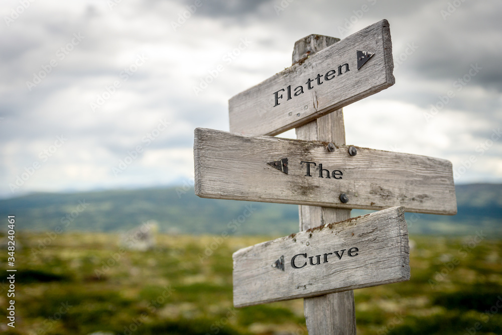 flatten the curve text engraved on old wooden signpost outdoors in ...