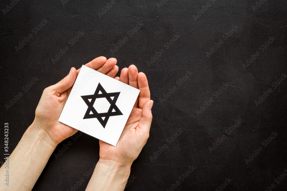Star of David sign in hands - religion Judaisim symbol - on black table ...