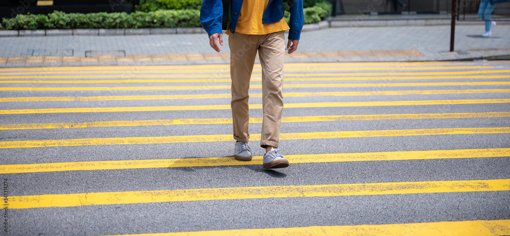 Walking across a pedestrian crossing, On foot across large city streets ...