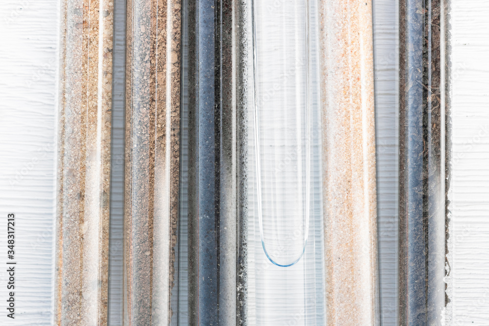 Samples of different types of soil in test tube on the table. Soil ...