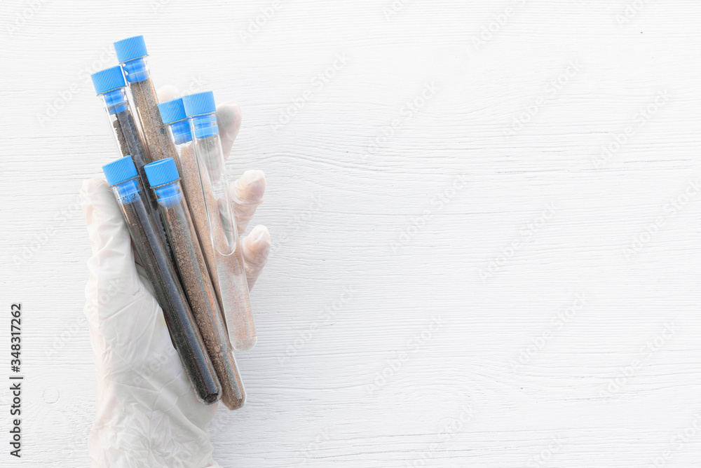 Samples of different types of soil in test tube on the table. Soil ...