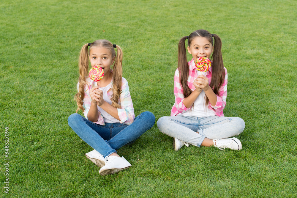 Melt in your mouth dessert. Happy children eat candy dessert on sticks ...